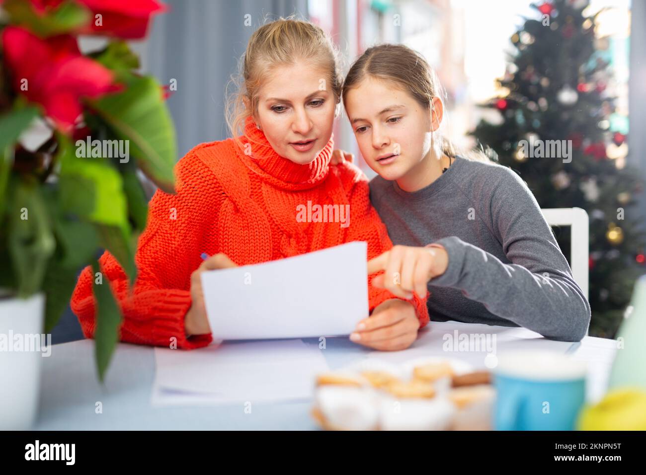 Woman and her daughter writing list of Christmas presents Stock Photo ...