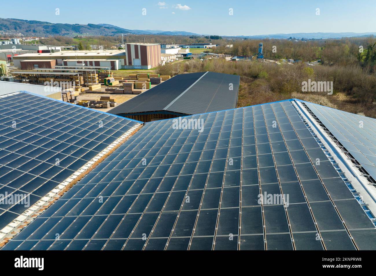 Aerial view of blue photovoltaic solar panels mounted on industrial ...