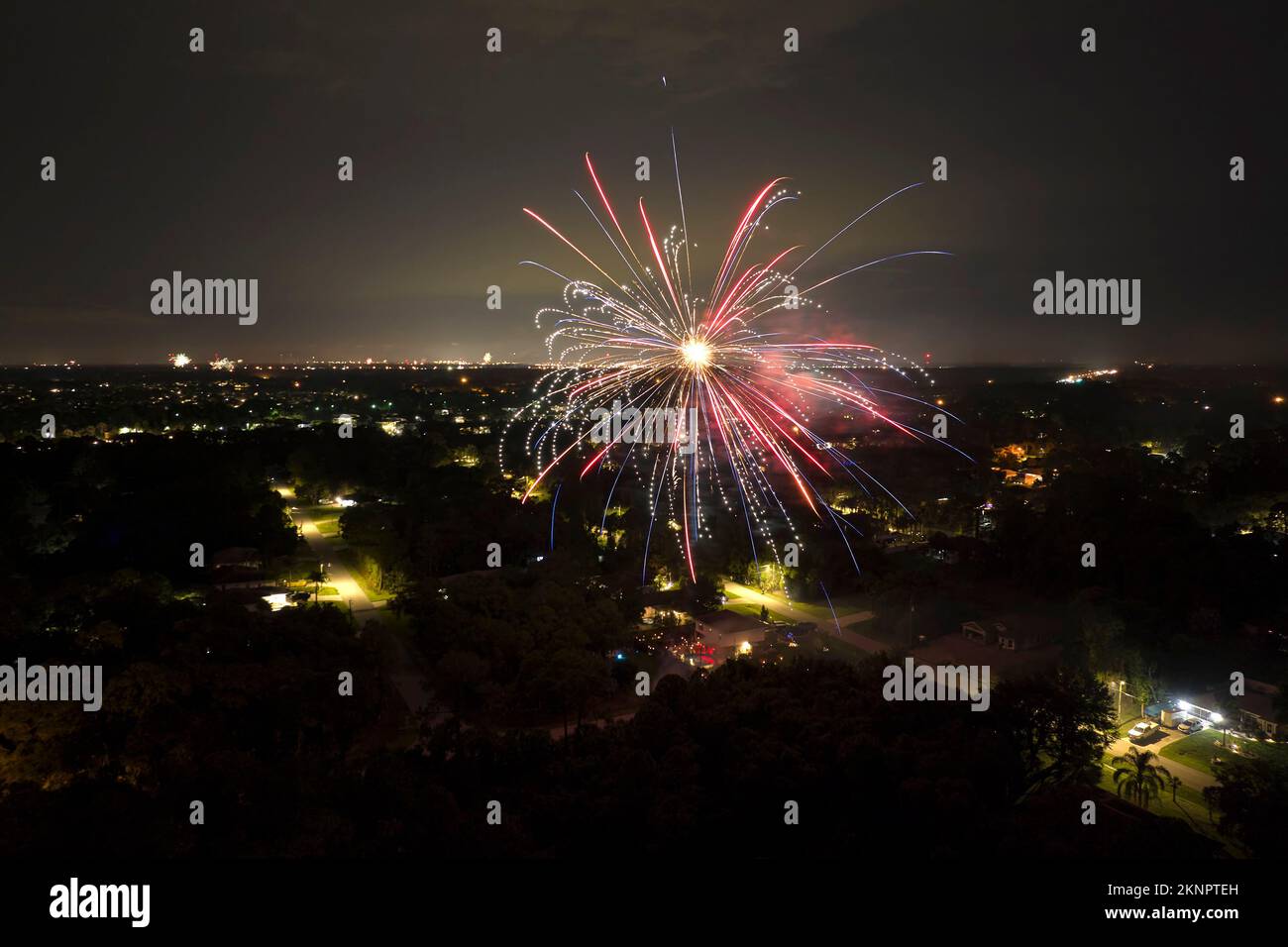 Aerial view of bright fireworks exploding with colorful lights over ...