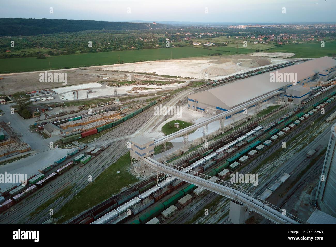 Aerial view of cargo train cars loaded with construction goods at ...