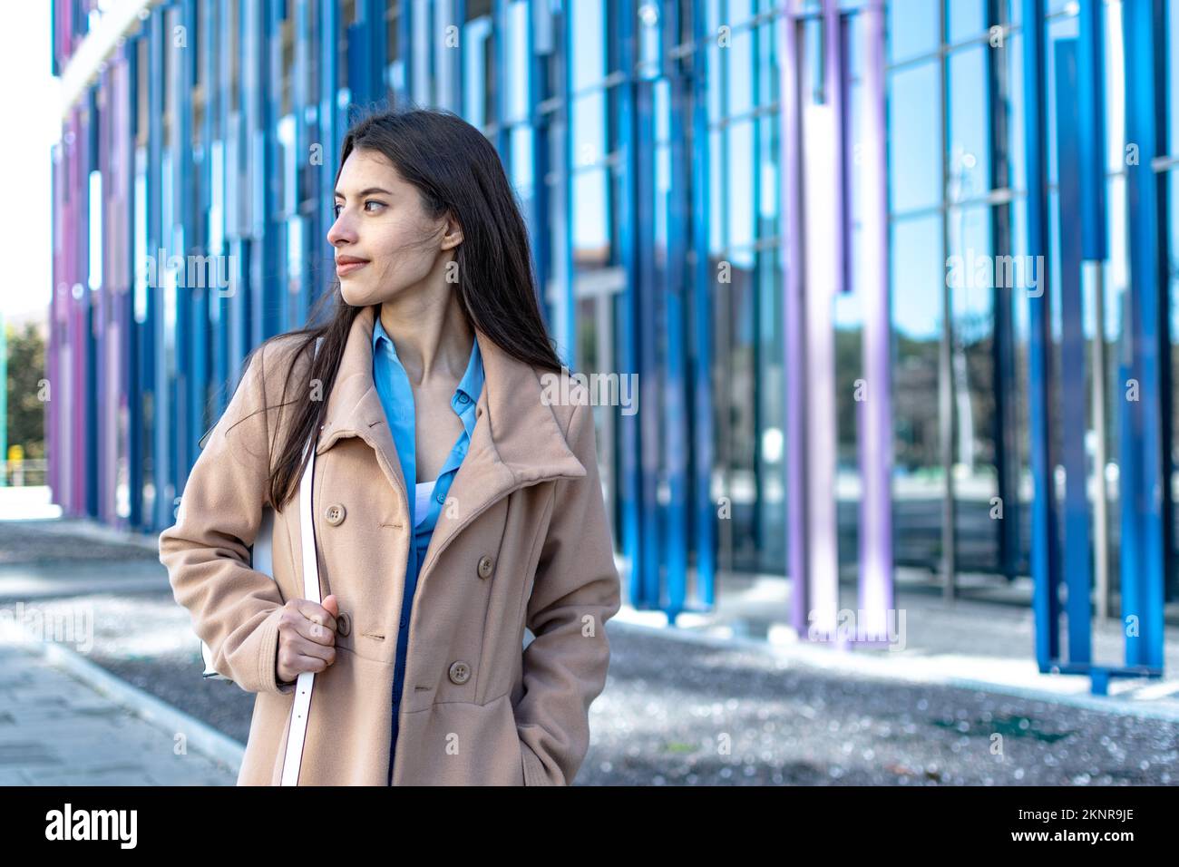Smiling young business woman in front of office building Stock Photo ...