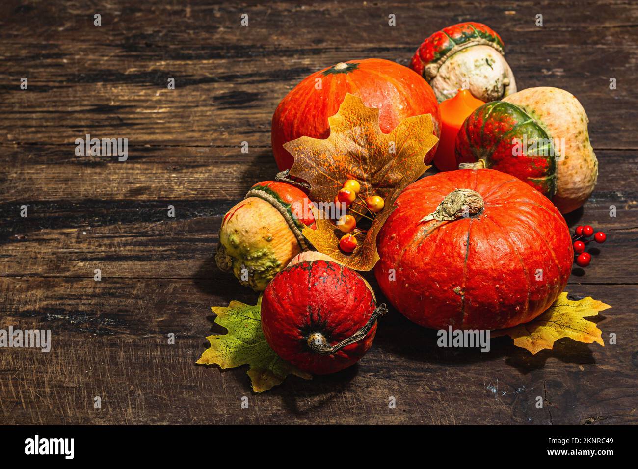 Autumn festive composition on old wooden background. Decorative pumpkin ...