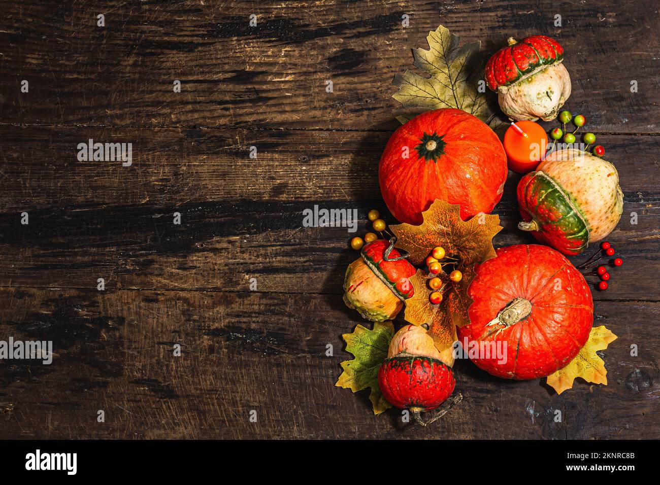 Autumn festive composition on old wooden background. Decorative pumpkin ...