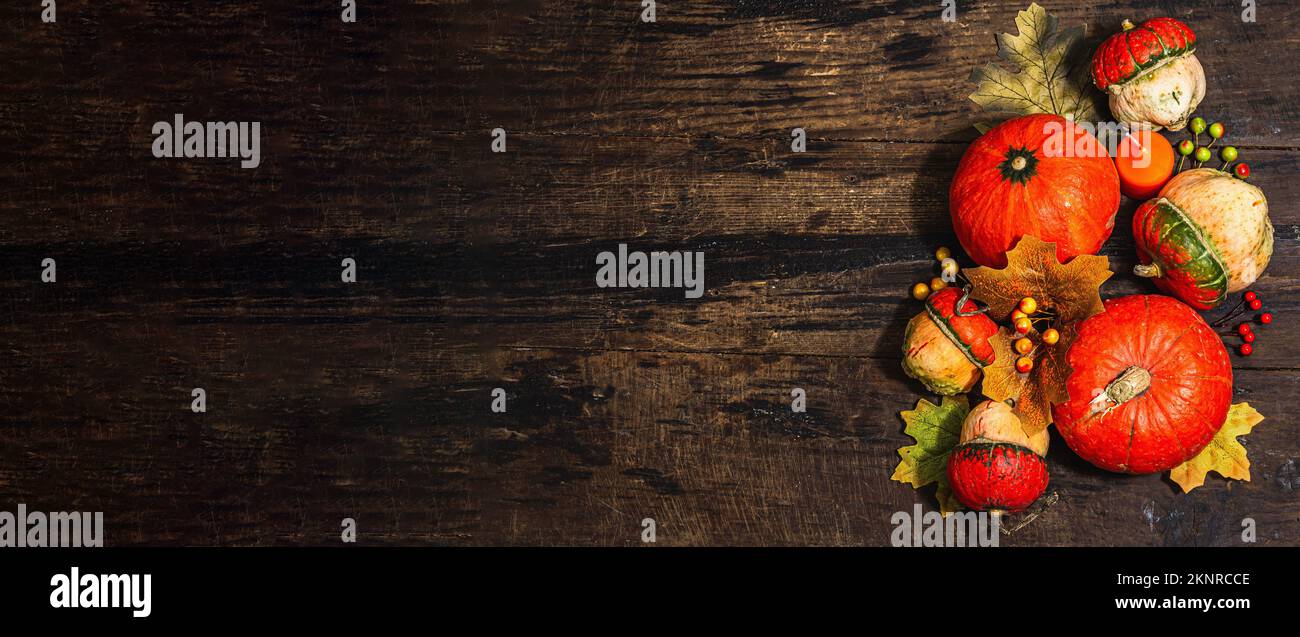 Autumn festive composition on old wooden background. Decorative pumpkin ...