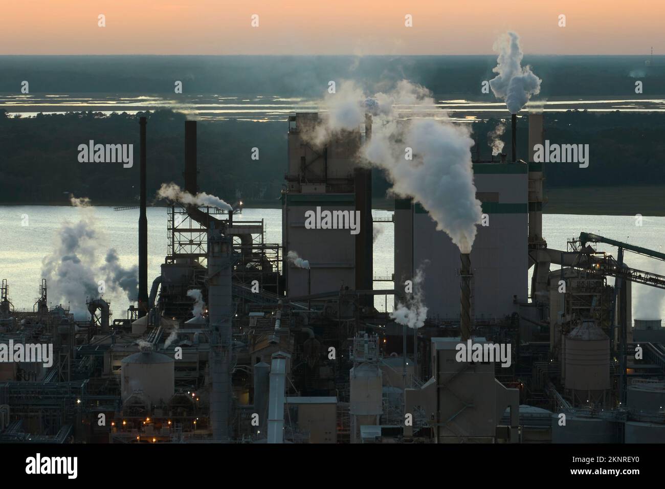 Aerial view of wood processing factory with smoke from production ...