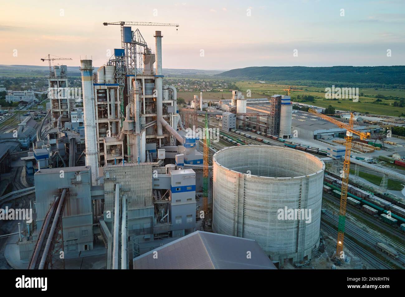 Cement plant with high factory structure and tower cranes at industrial ...