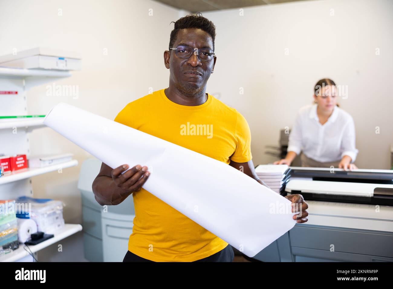 Middle-aged African American man holding large format paper whatman in ...