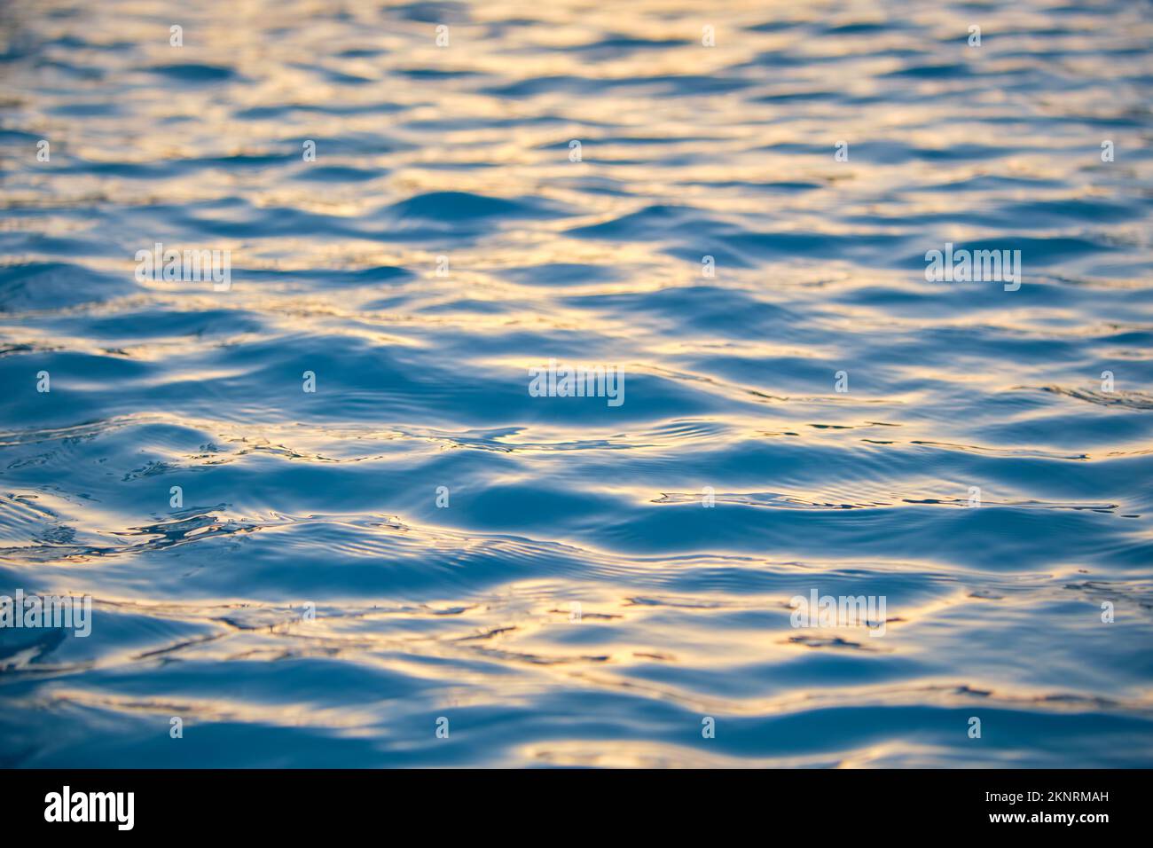 Closeup seascape surface of blue sea water with small ripple waves ...