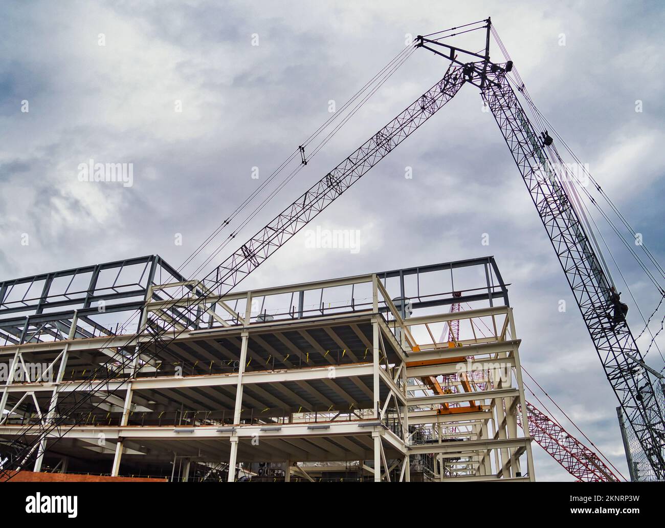 Crane on construction project with stormy sky Stock Photo - Alamy