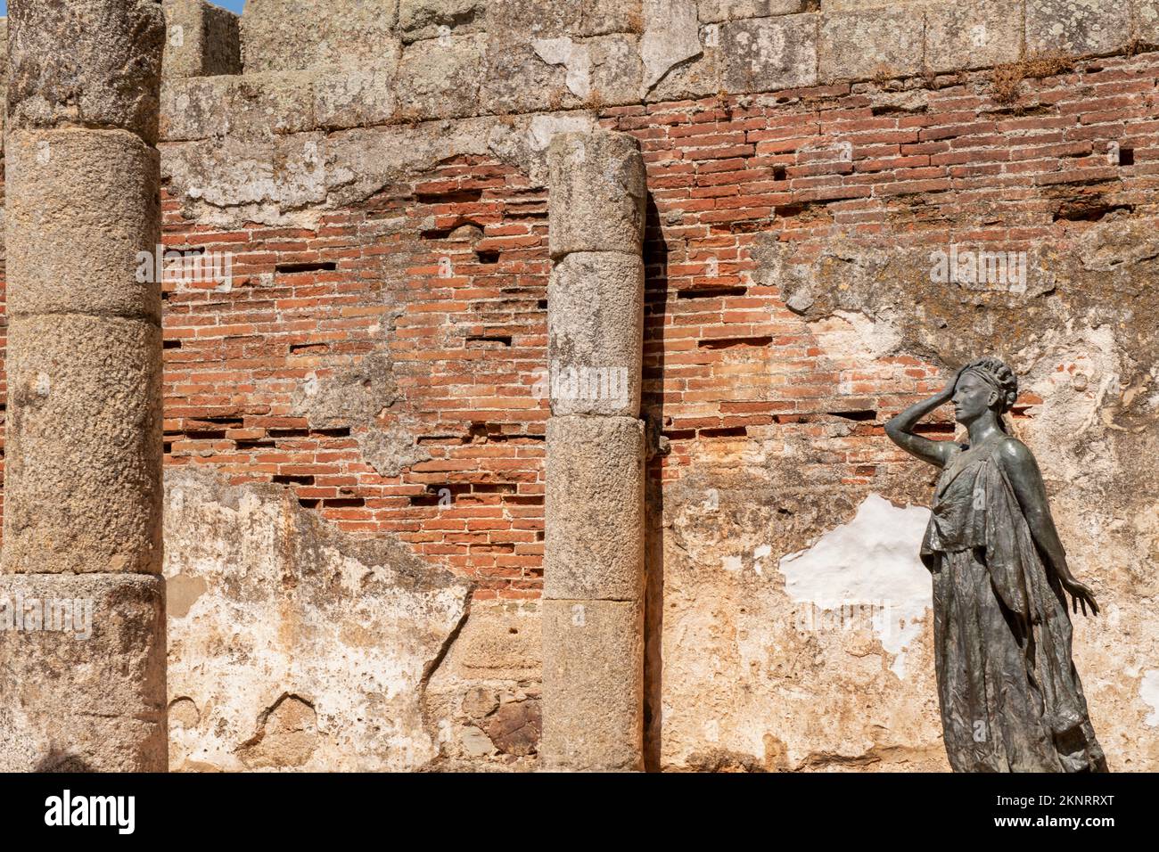 Bronze statue of the actress Margarita Xirgu between columns and walls ...
