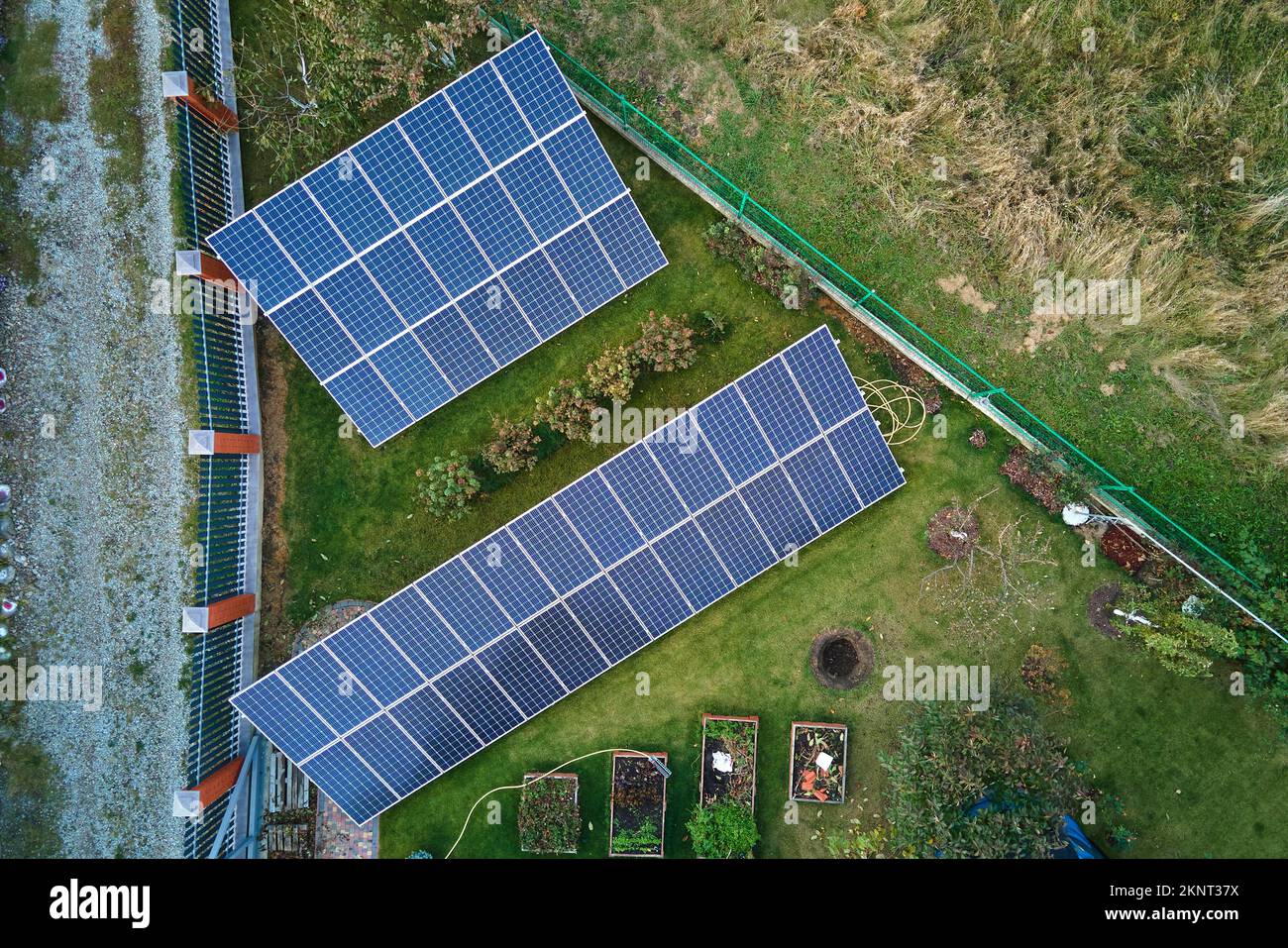 Solar photovoltaic panels mounted on stand-alone frame on backyard ...