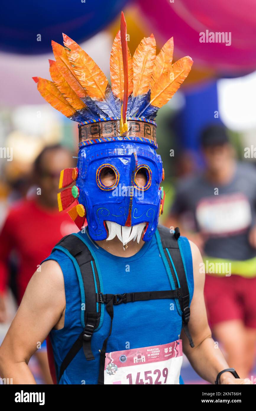 A masked man running the International Marathon of Mexico city on the ...