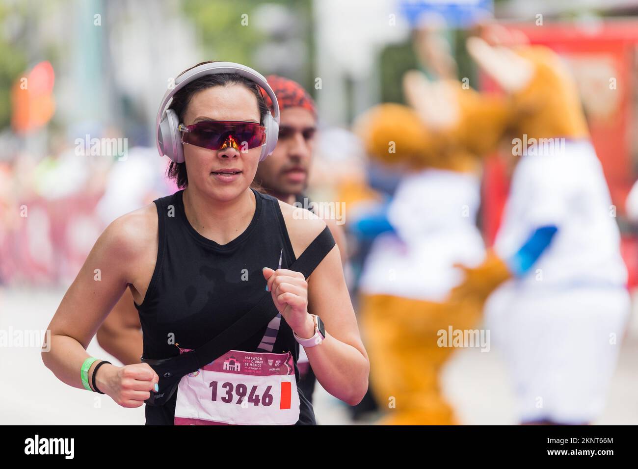 A woman running the International Marathon of Mexico city on the street ...