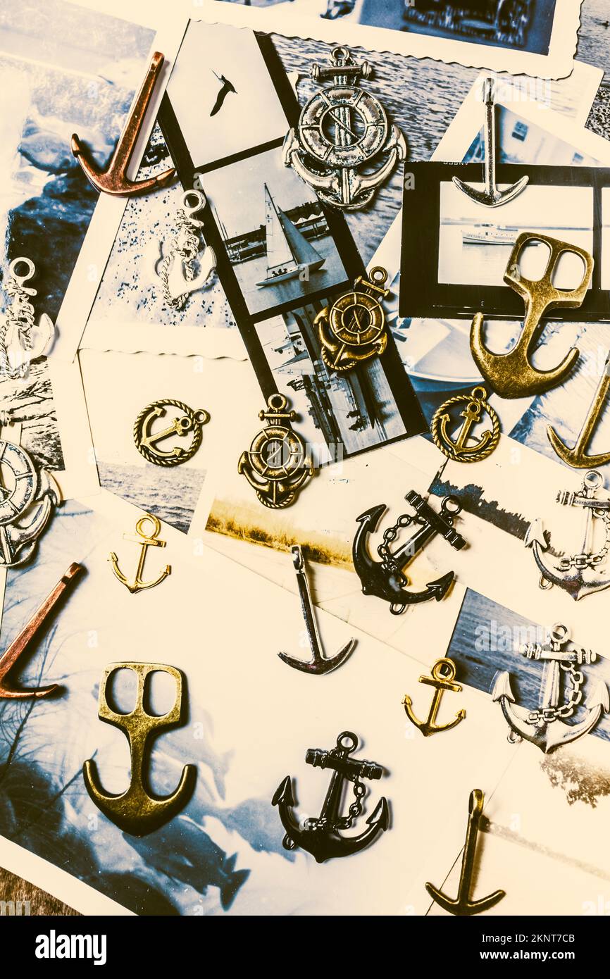 Still life art on a scatter of sea anchor charms on old nautical voyage ...
