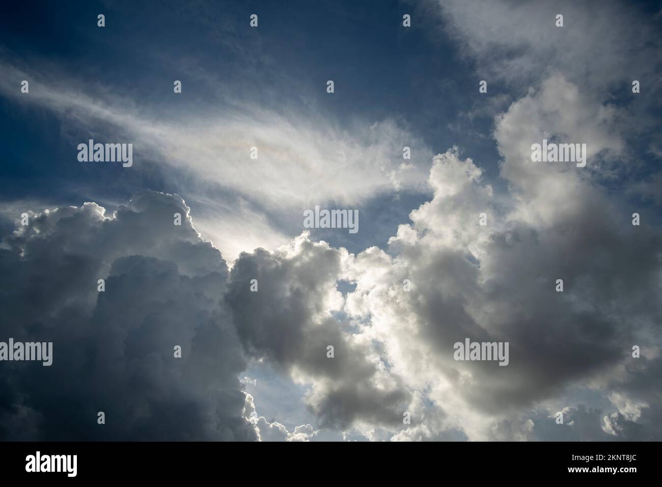 White fluffy cumulonimbus clouds forming before thunderstorm on summer ...