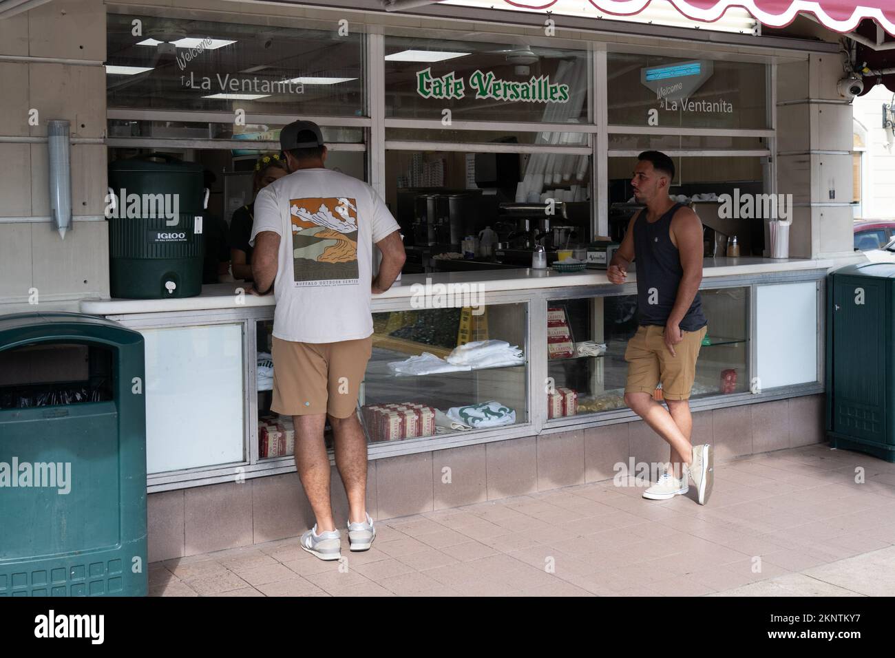 People are seen at the Cuban coffee spot at the restaurant. A server ...