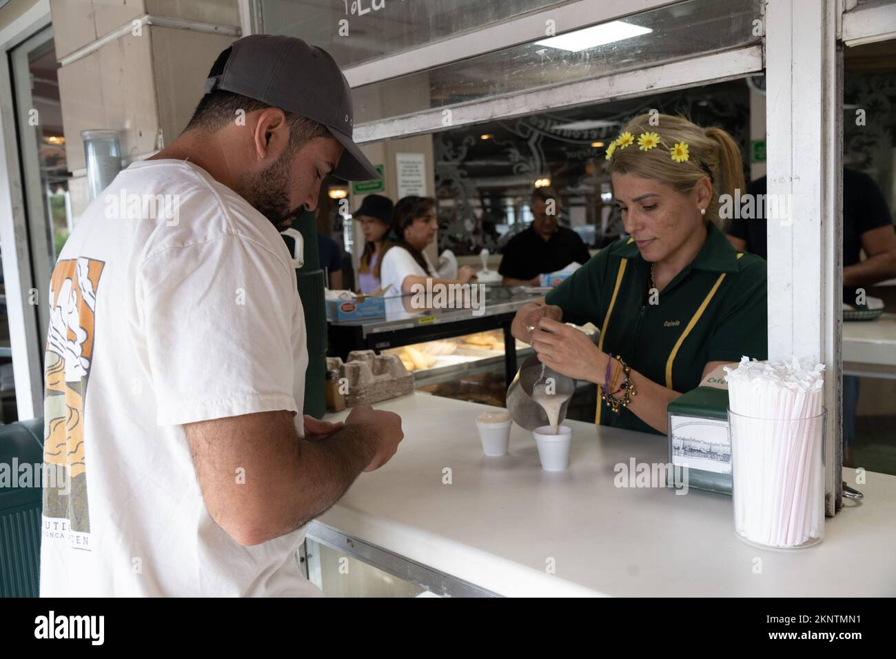 A server makes Cordoios for a customer at the restaurant. Felipe Valls ...