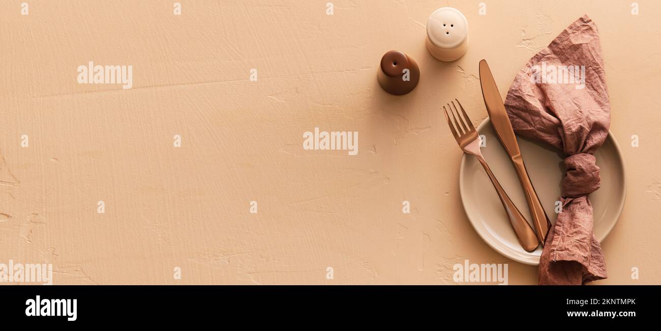 Simple table setting on beige background with space for text Stock ...