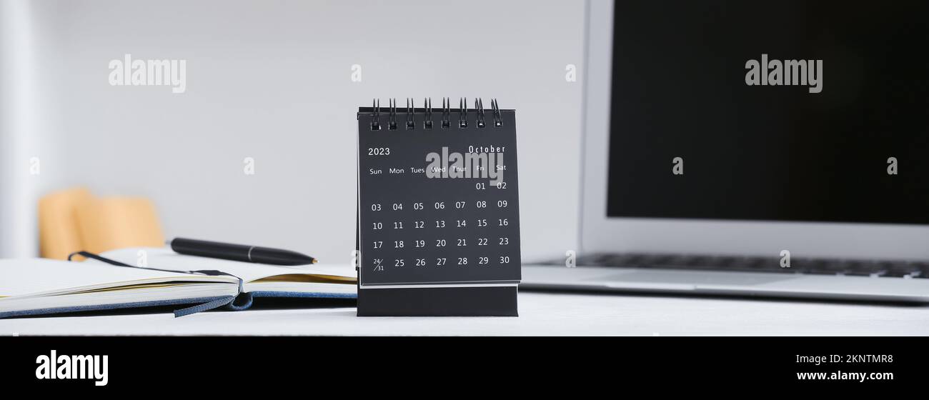 Flip paper calendar and laptop on table in office Stock Photo - Alamy