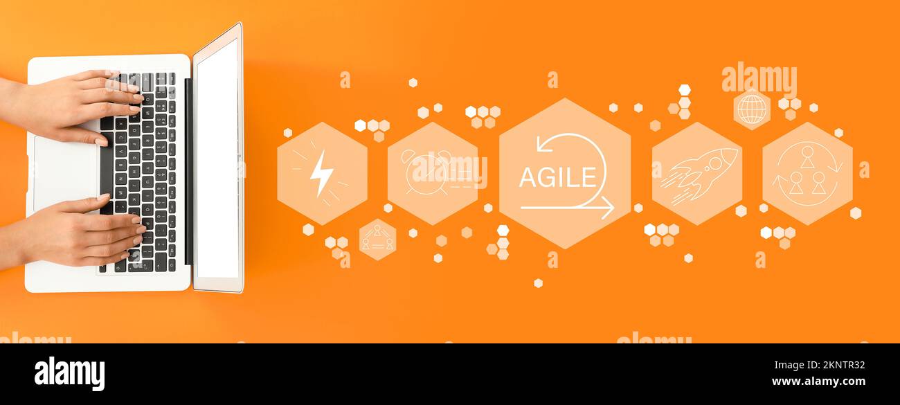 Female hands with modern laptop on orange background. Concept of agile ...