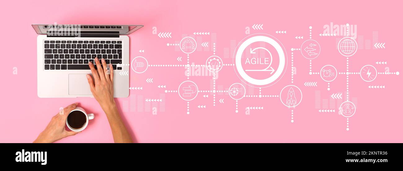 Female hands with modern laptop and cup of coffee on pink background ...