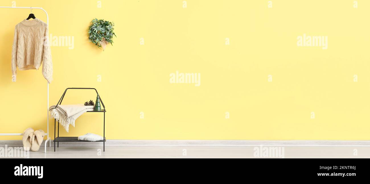 Interior of dressing room with Christmas mistletoe wreath, rack with ...