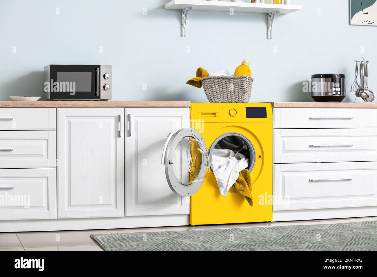 Interior of kitchen with modern yellow washing machine Stock Photo - Alamy