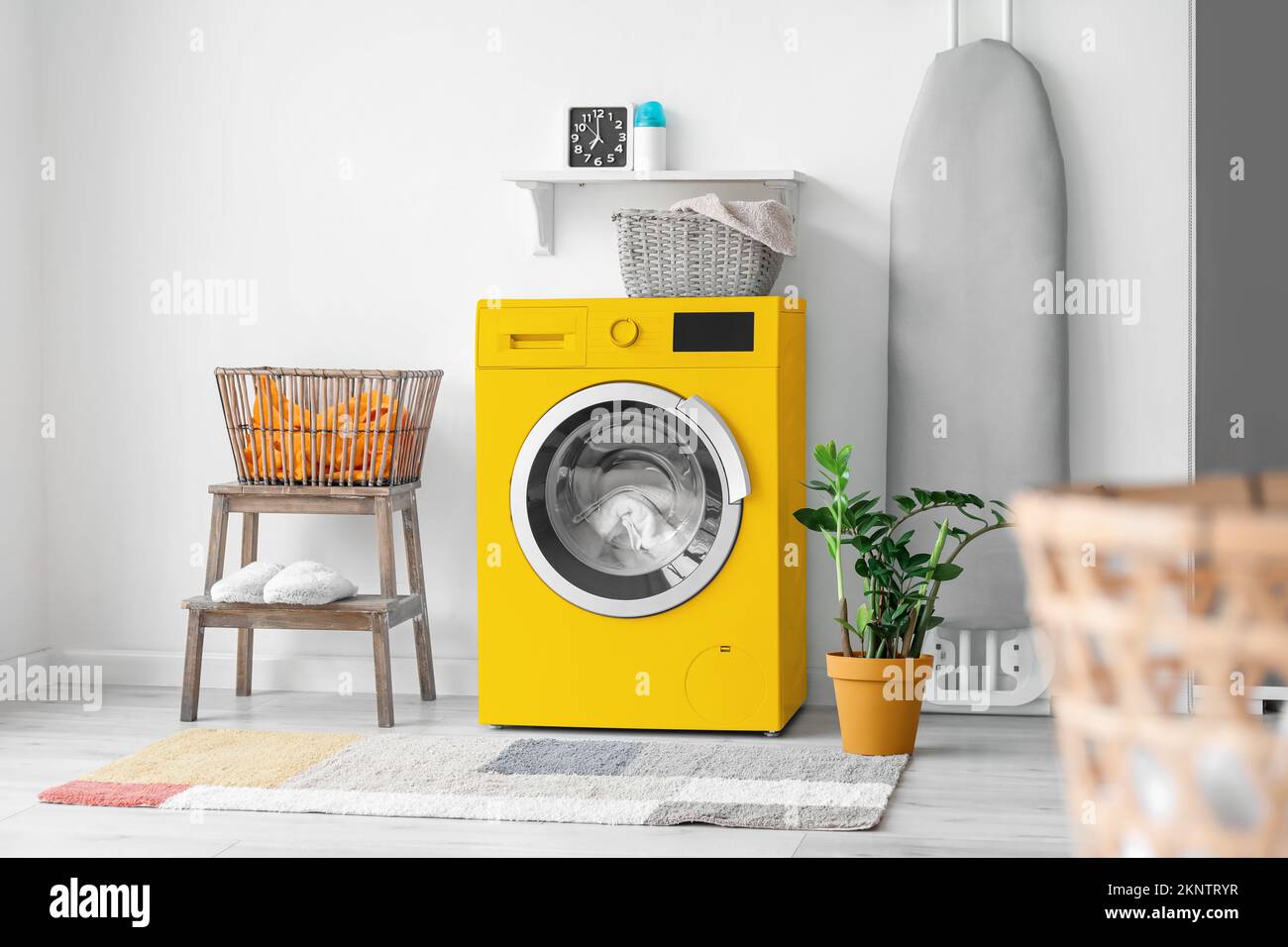 Interior of bathroom with modern yellow washing machine Stock Photo - Alamy