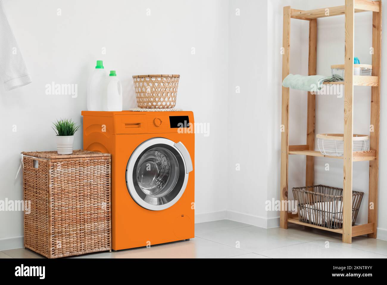 Interior of bathroom with modern orange washing machine Stock Photo - Alamy