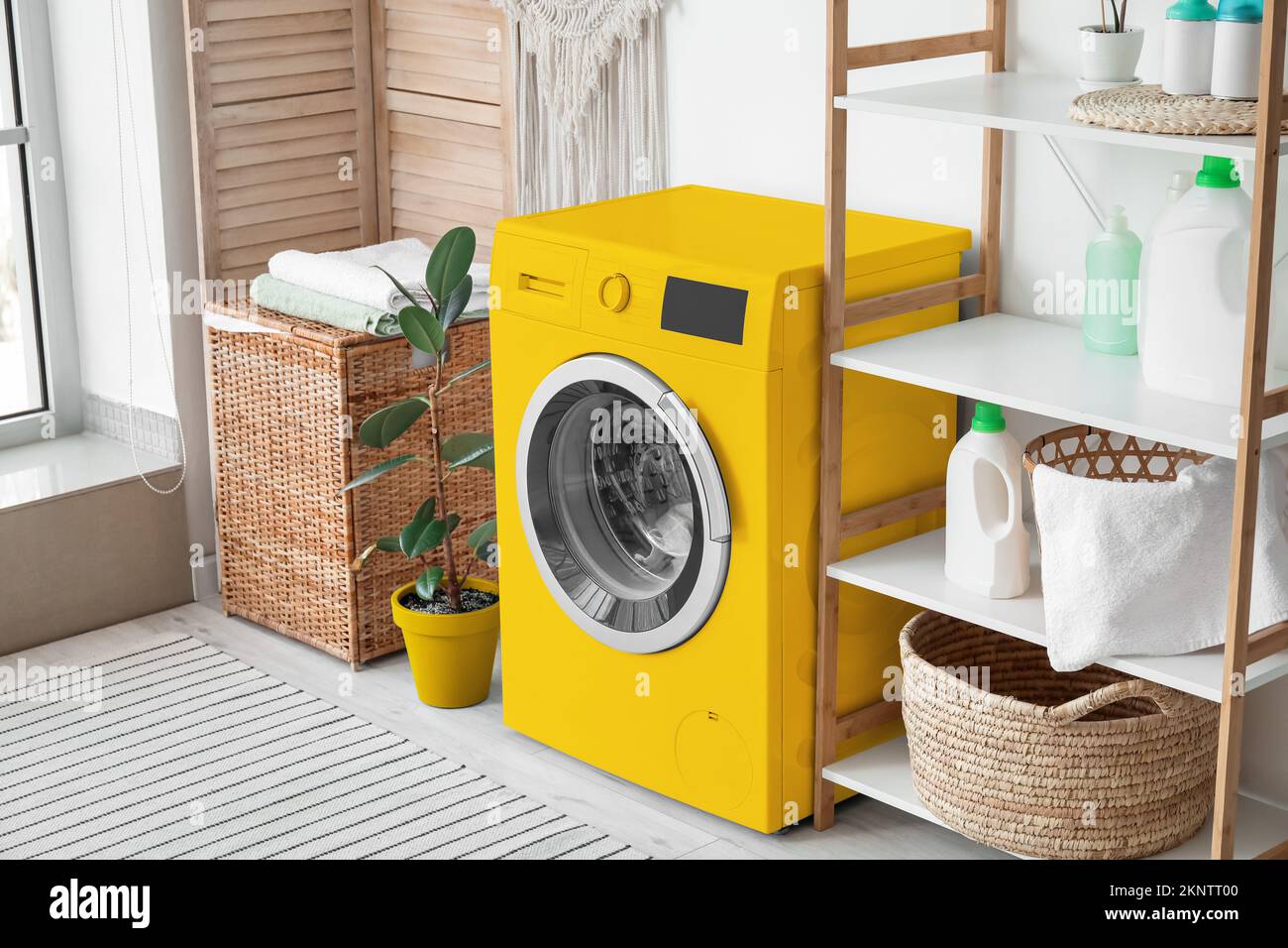 Interior of bathroom in eco style with modern yellow washing machine ...