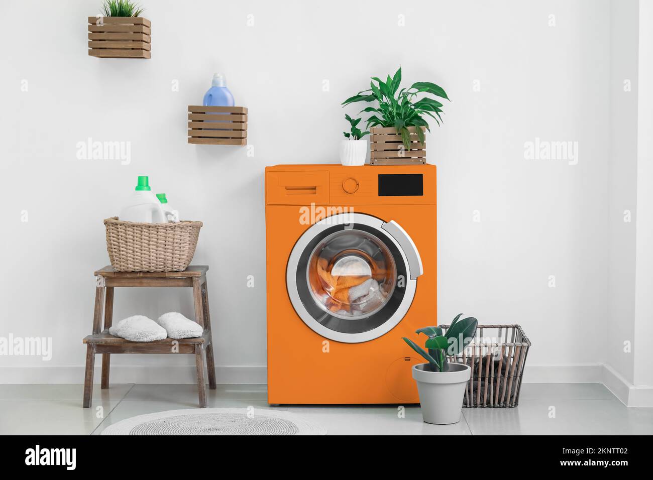 Interior of bathroom with orange washing machine Stock Photo - Alamy
