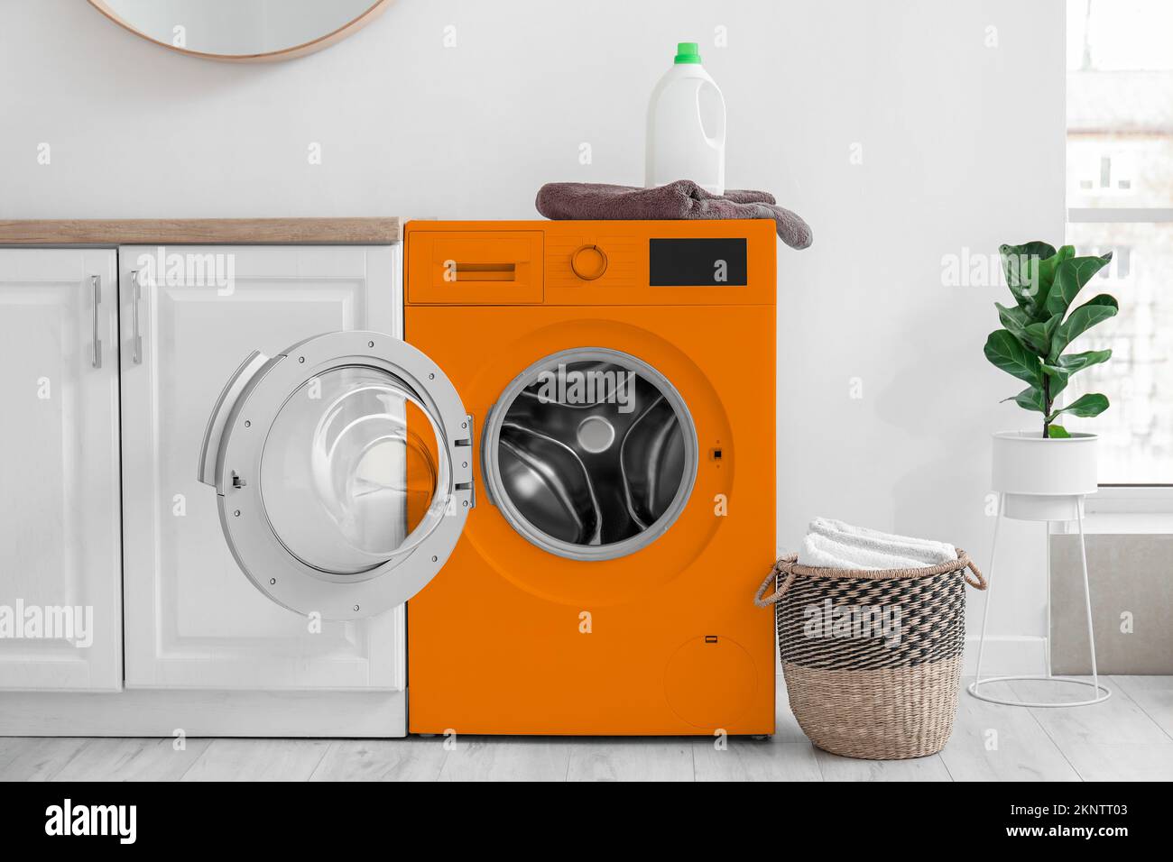 Interior of kitchen with modern orange washing machine Stock Photo - Alamy
