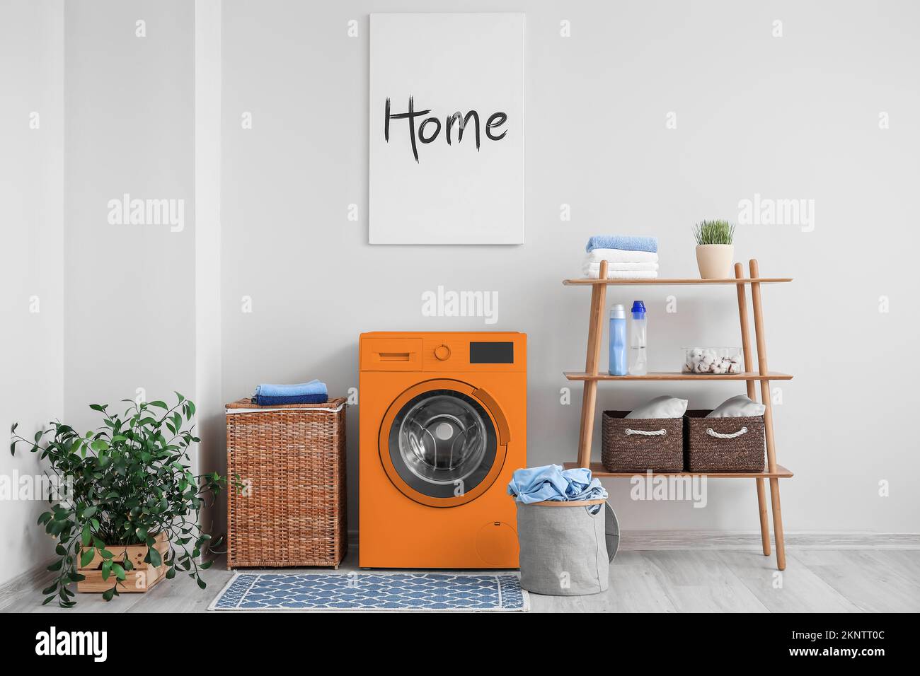 Interior of modern home laundry room with bright orange washing machine ...