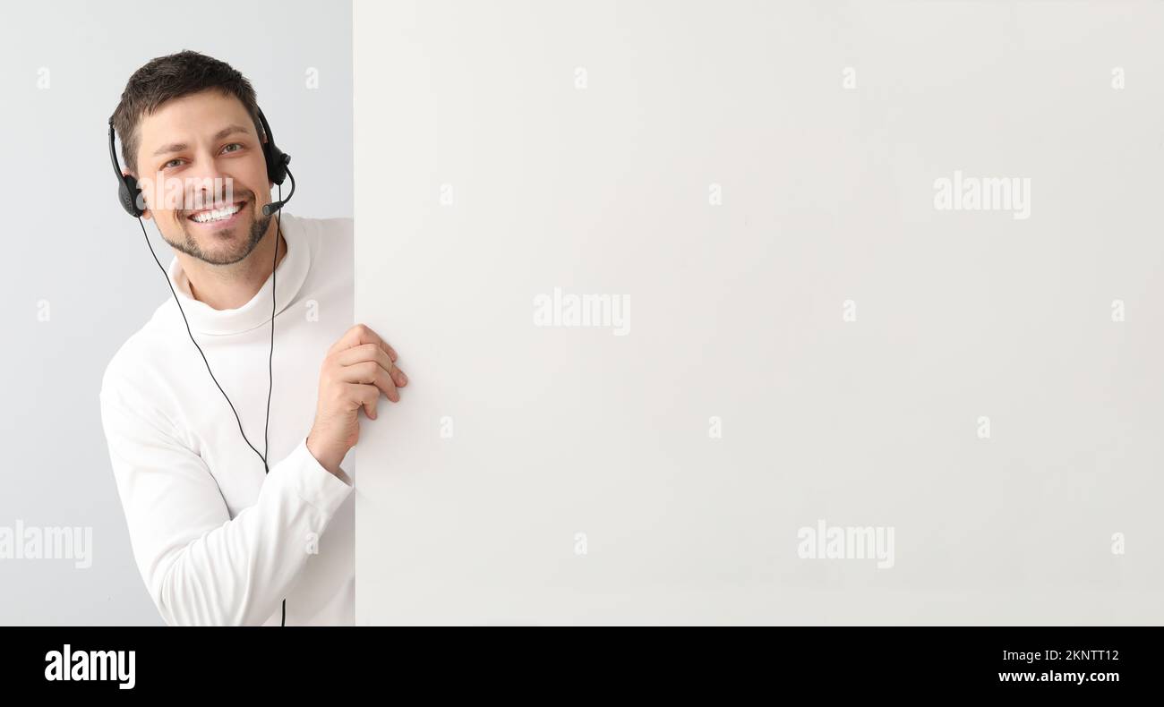 Technical support agent with blank poster on light background Stock ...