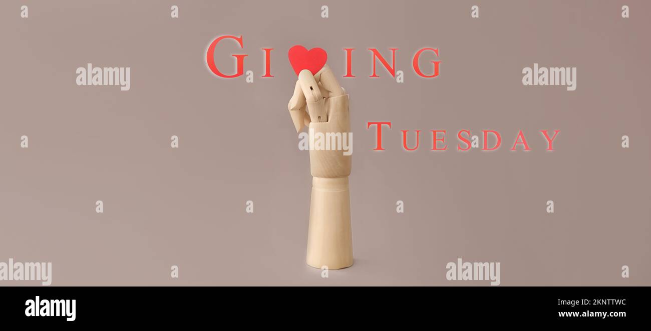 Banner with wooden hand, heart and text GIVING TUESDAY on grey ...