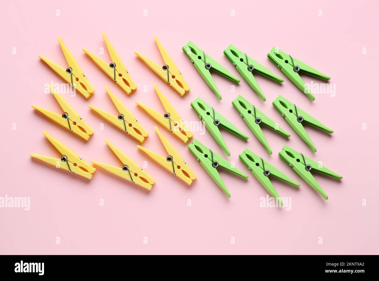 Different plastic clothespins on pink background Stock Photo - Alamy