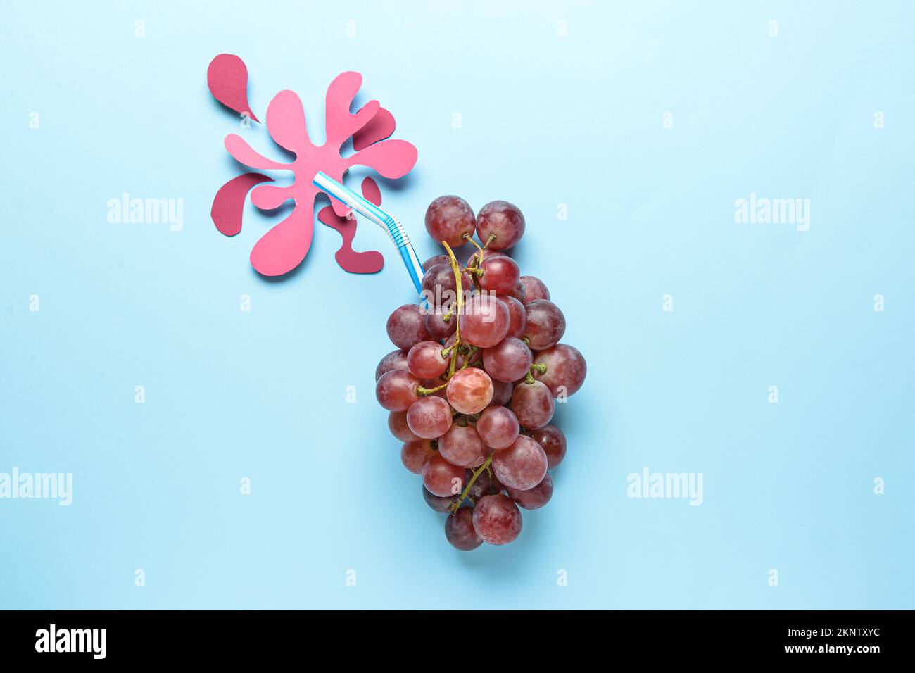 Composition with bunch of grapes, straw and splash on color background ...