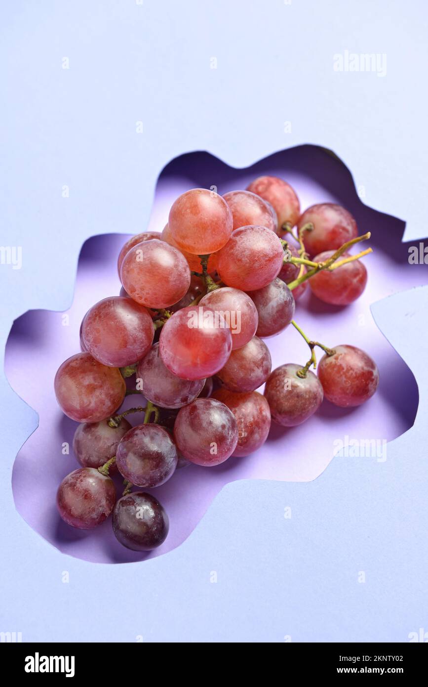 Composition with grape on color background, closeup Stock Photo - Alamy