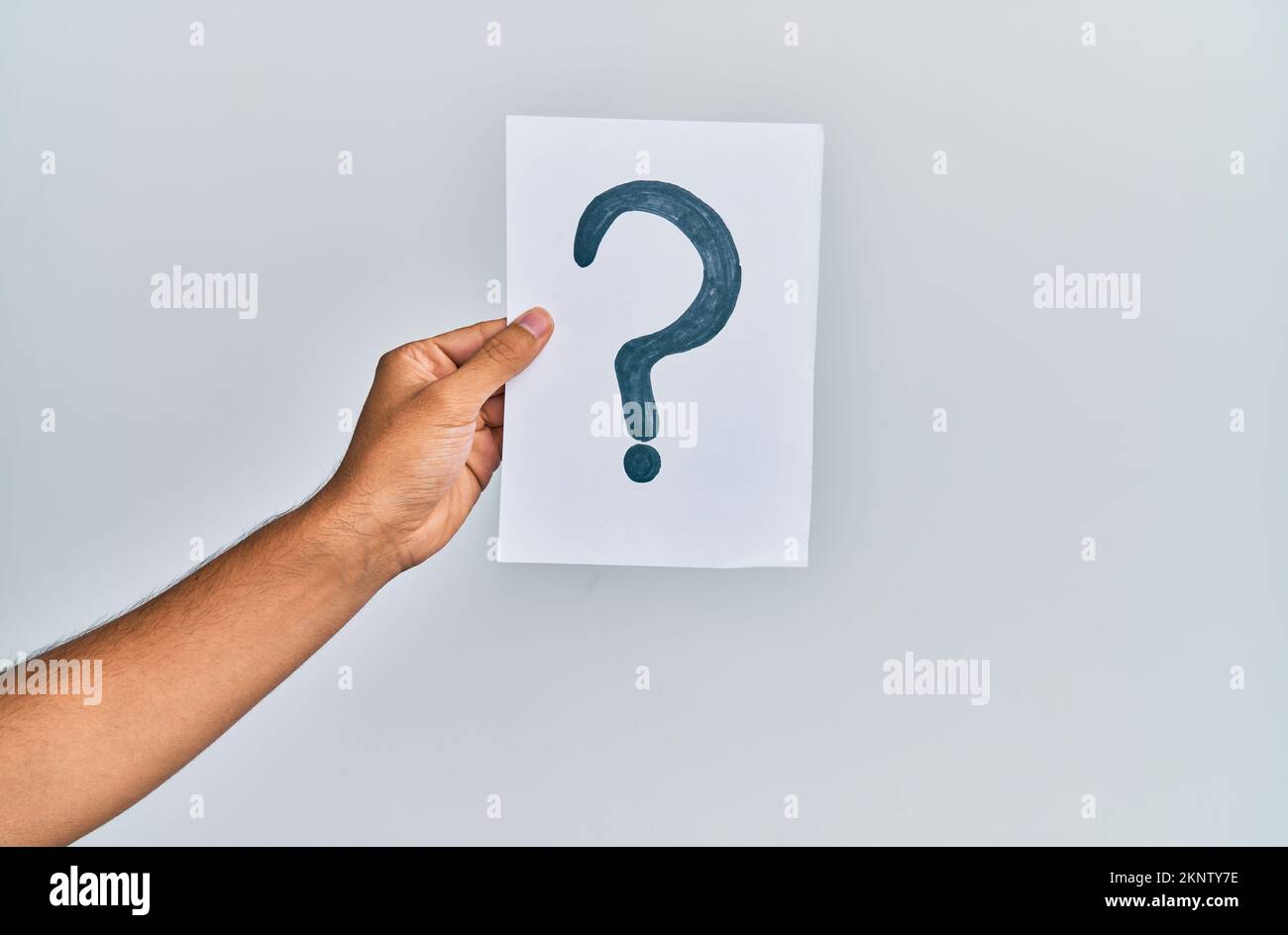 Hand of caucasian man holding paper with question mark over isolated ...