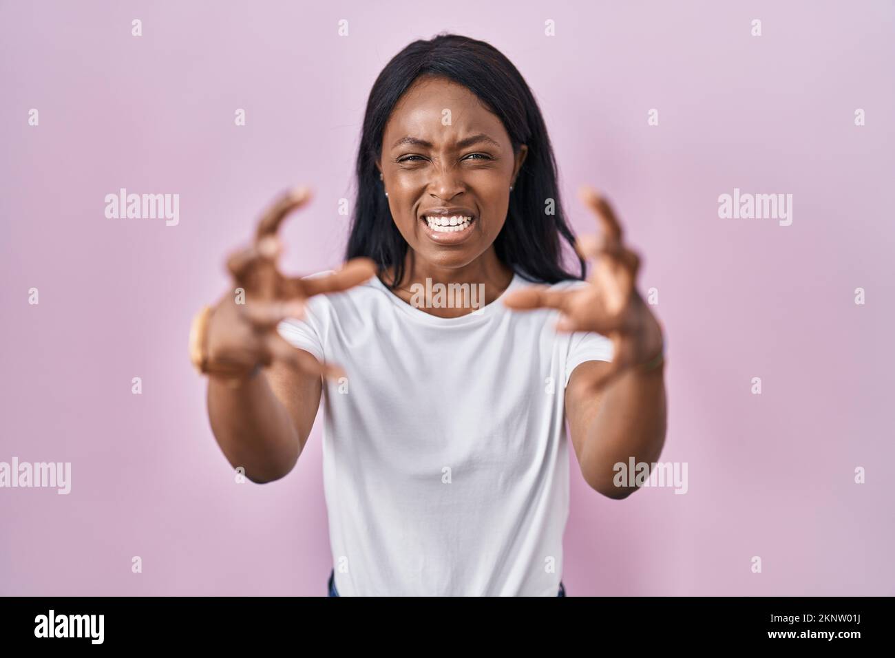 African young woman wearing casual white t shirt shouting frustrated ...
