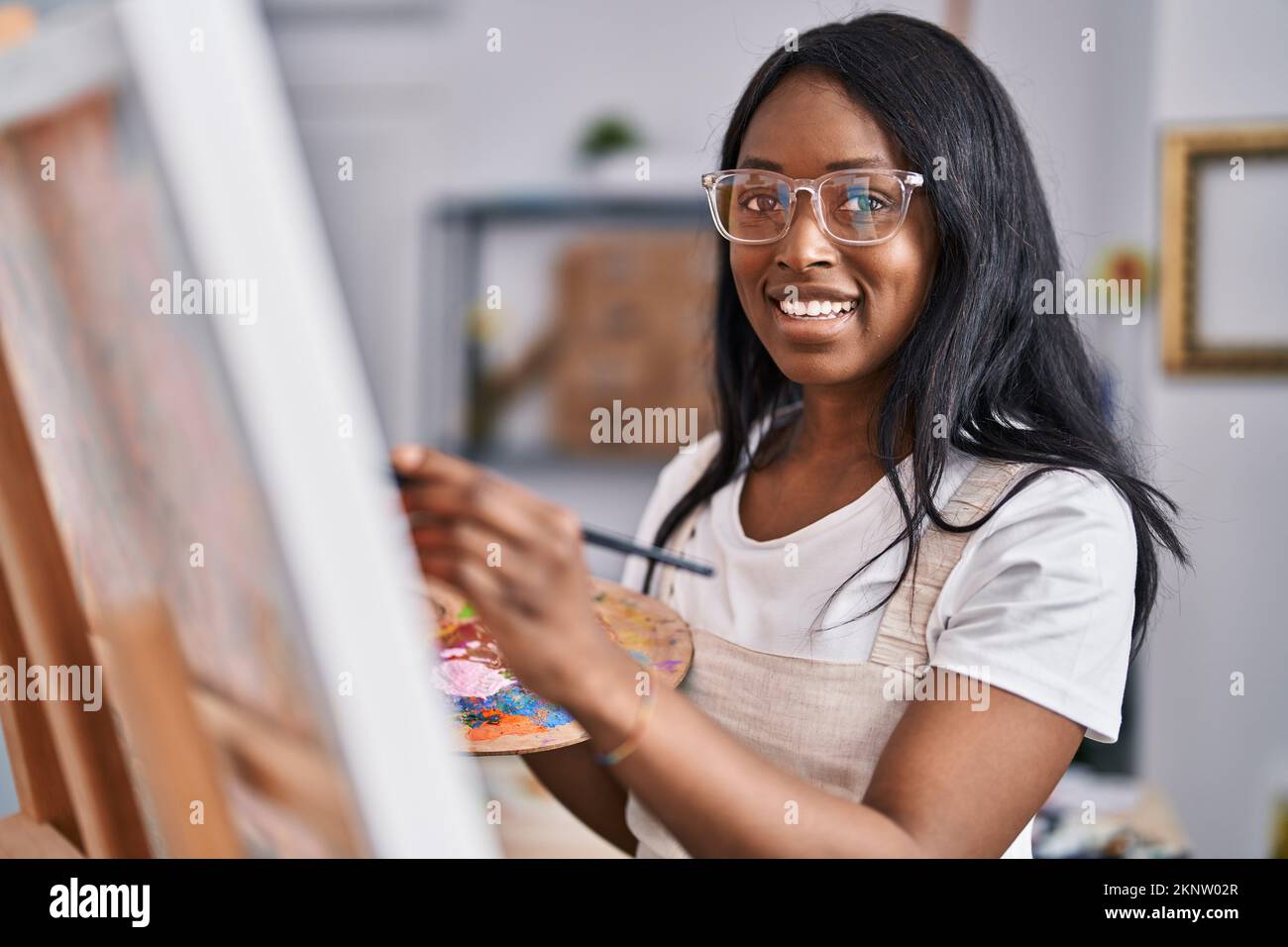Young african american woman artist smiling confident drawing at art ...