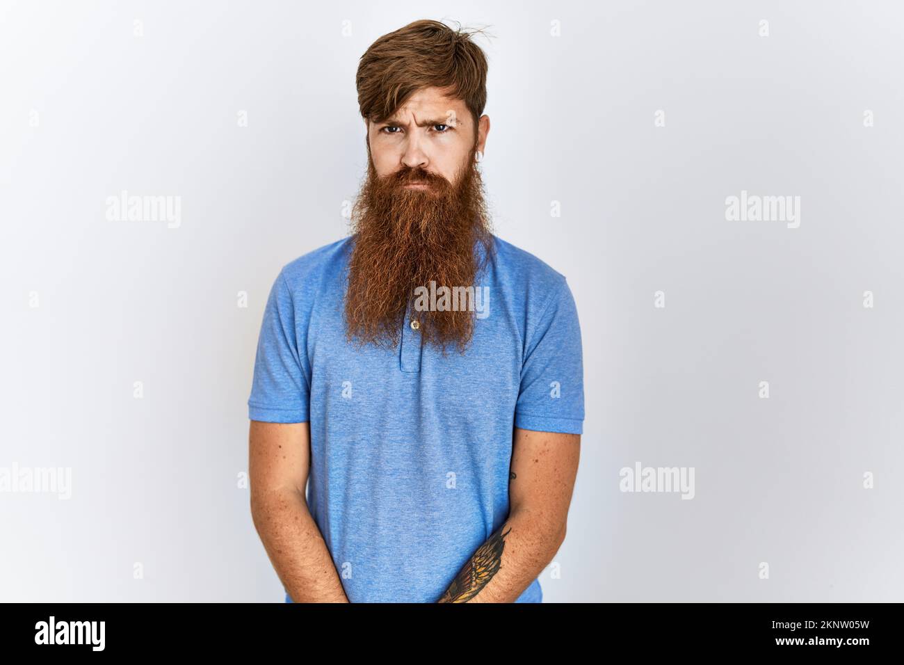 Caucasian man with long bear standing over isolated background skeptic ...