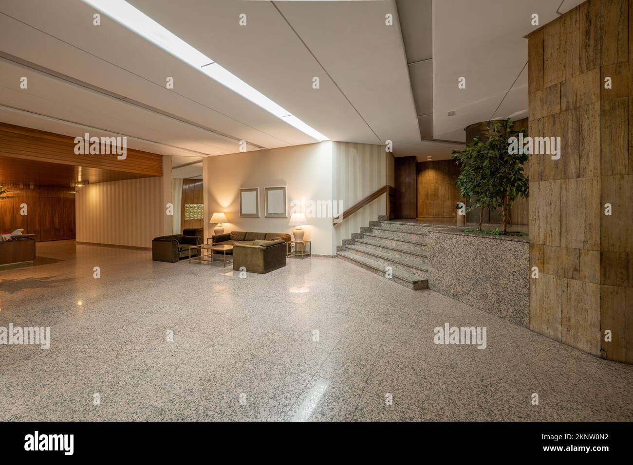 Portal of a residential house with stairs and granite floors, papered ...
