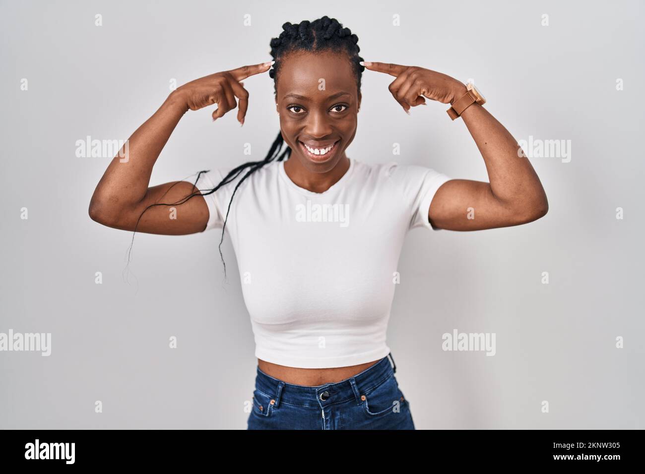 Beautiful black woman standing over isolated background smiling ...