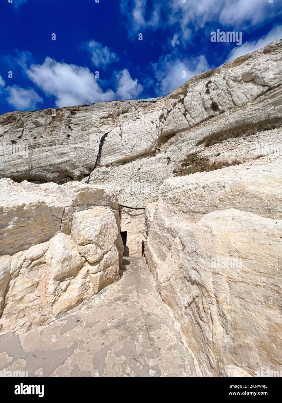 Pathway in high cliff against sky background Stock Photo - Alamy