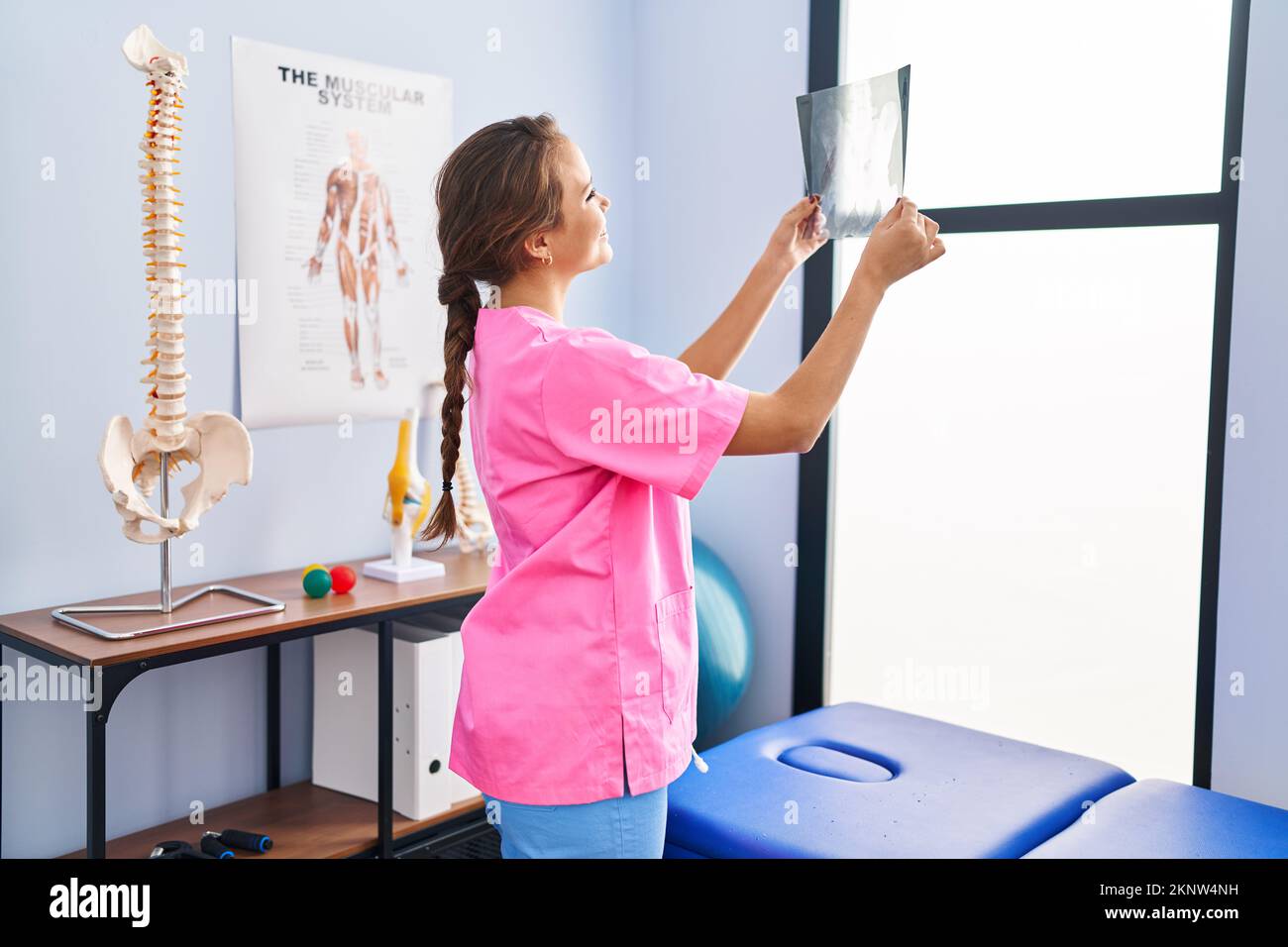 Young beautiful hispanic woman physiotherapist smiling confident ...