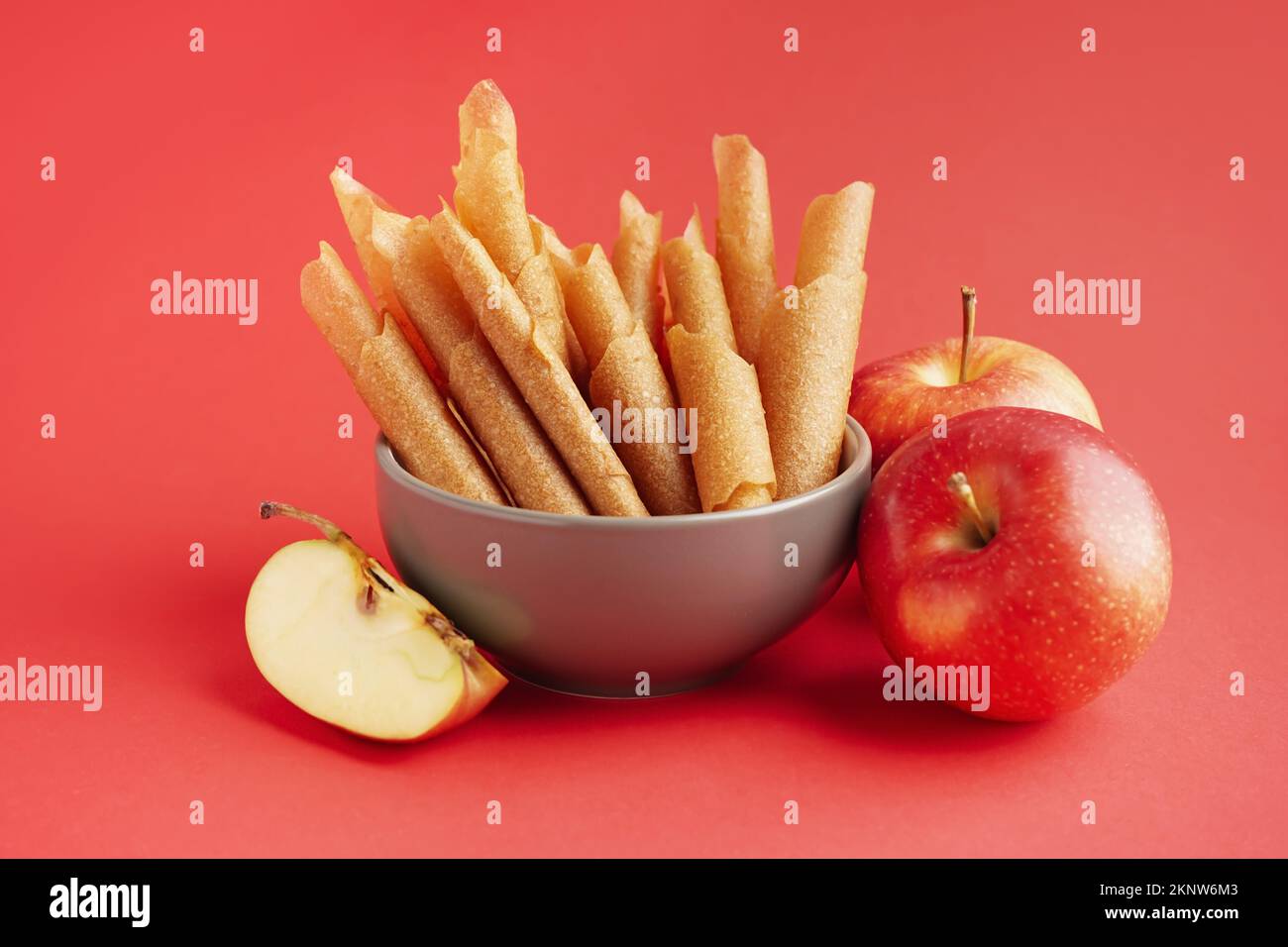 Bowl of tasty apple pastilles on red background Stock Photo - Alamy