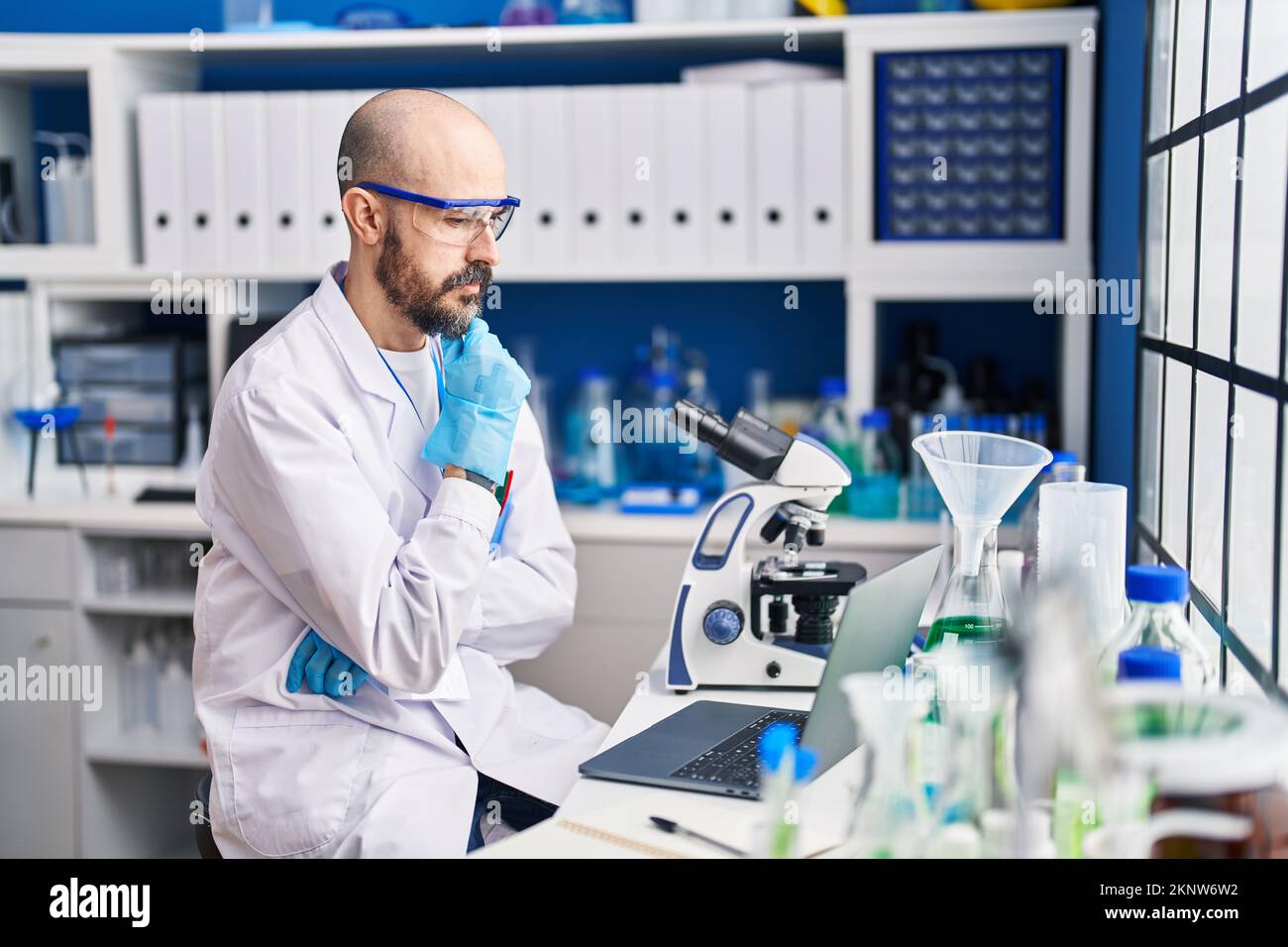 Young bald man scientist having video call at laboratory Stock Photo ...