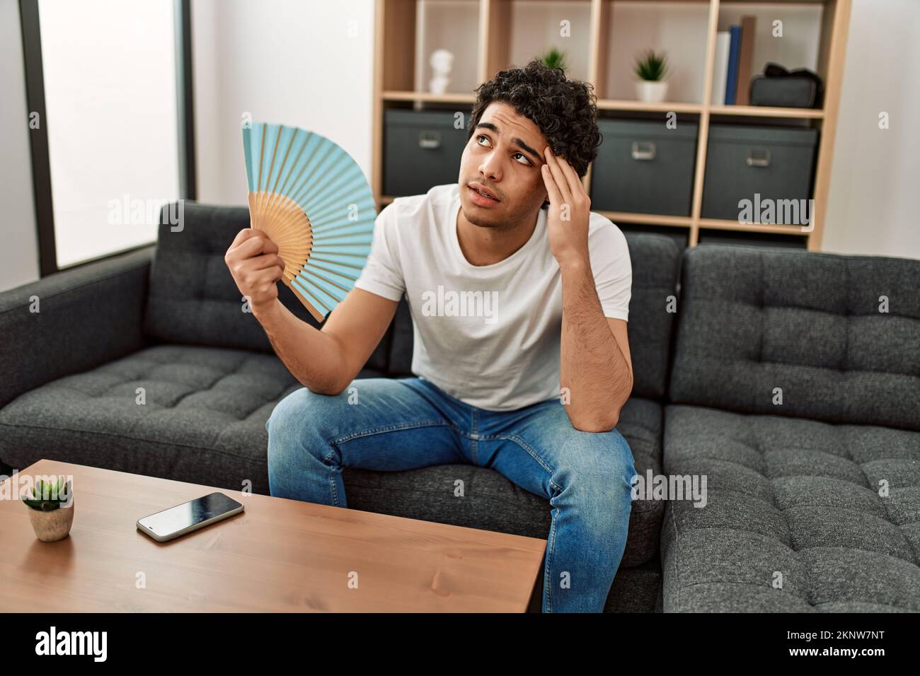 Man holding fan to cool the face hi-res stock photography and images ...