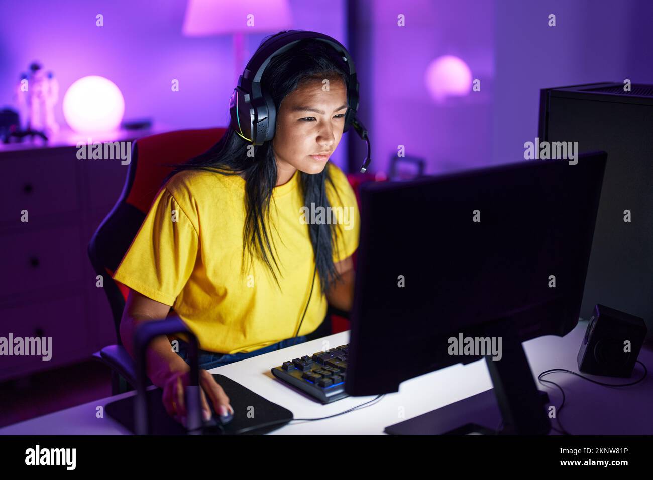 Young beautiful latin woman streamer playing video game using computer ...